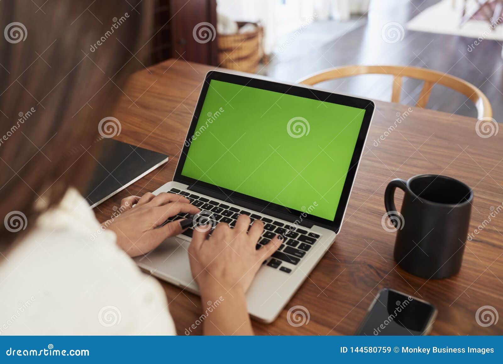 Over Shoulder View of Woman Sitting at Table Using Laptop Computer at ...