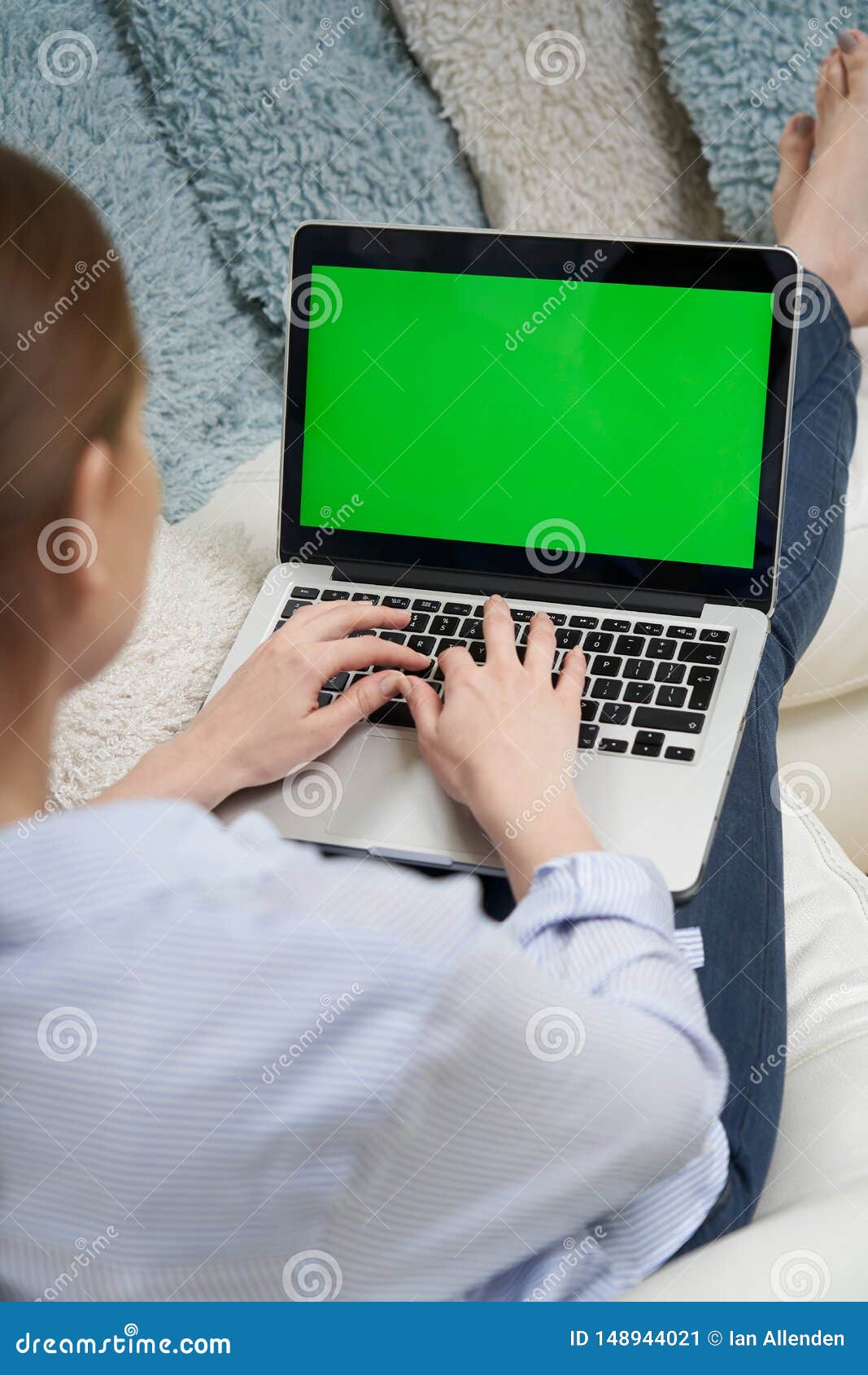 Over the Shoulder View of Woman Lying on Sofa Using Green Screen Laptop ...