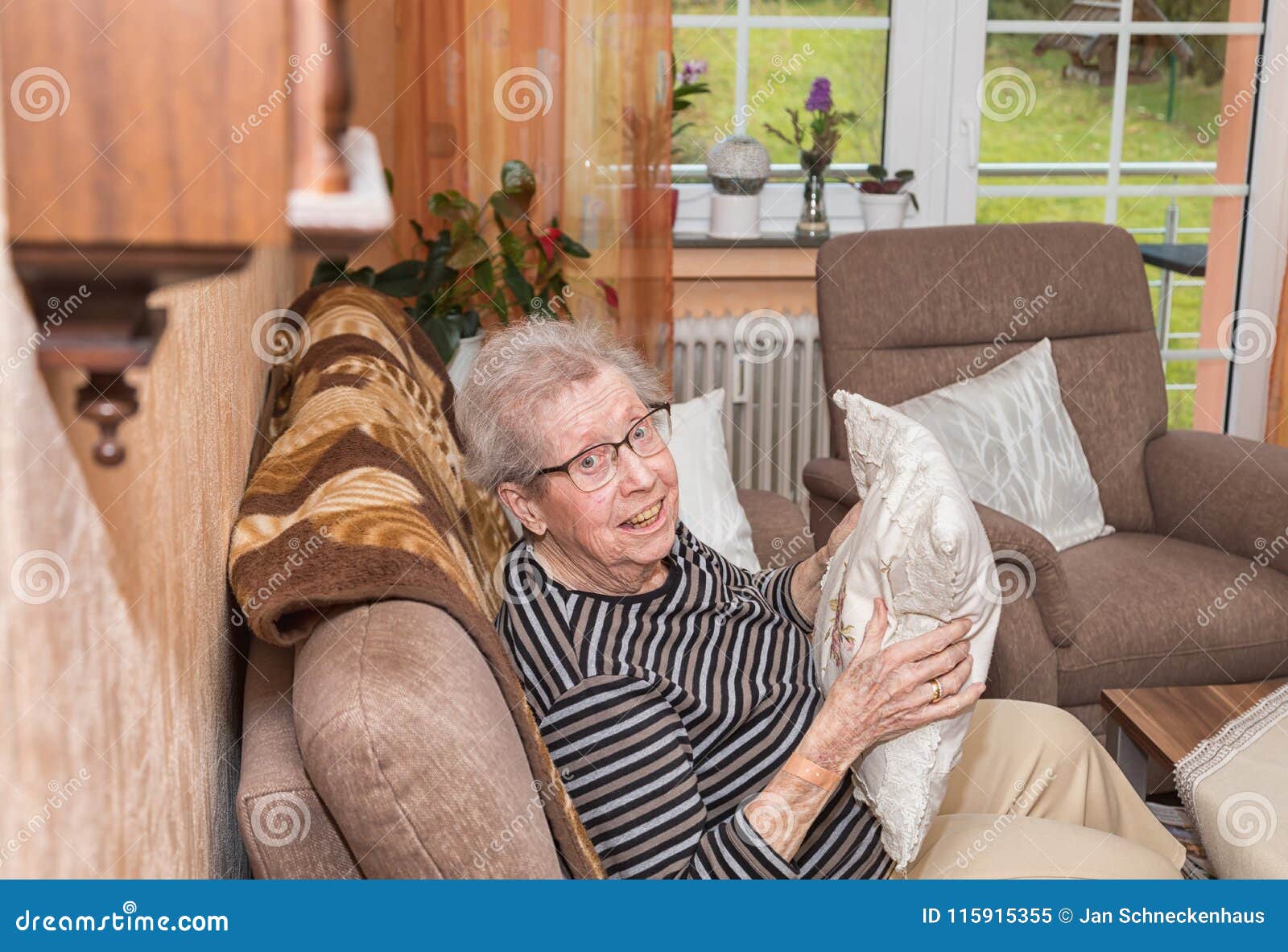 61 Year Old Grandmother With An Amused Face Listens To An Entertaining
