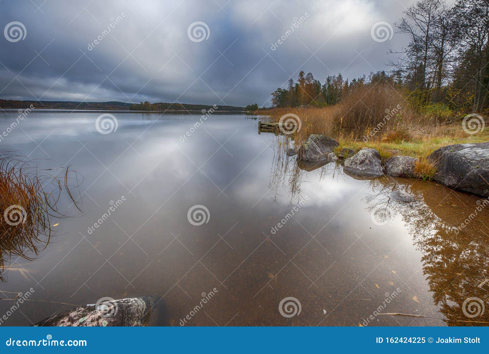 Overcast sky over lake stock image. Image of meadow - 162424225