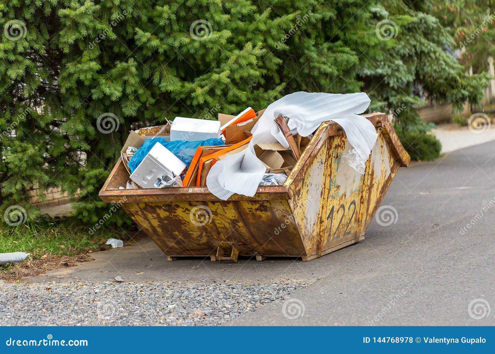 Overflowing Rusty Metal Container for Construction Waste with Cardboard ...