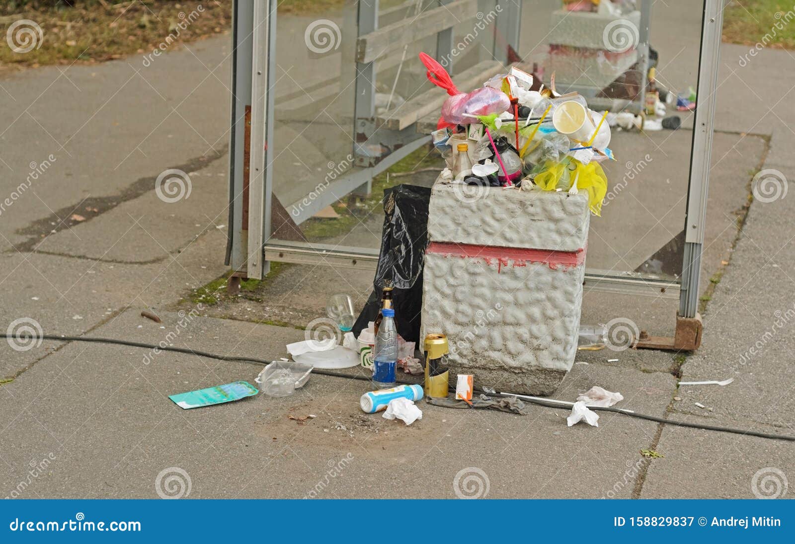 Overflowing Trash Can On Stone Pavement Background.The Plastic ... Overflowing Trash Can On Stone Pavement Background.The Plastic ...