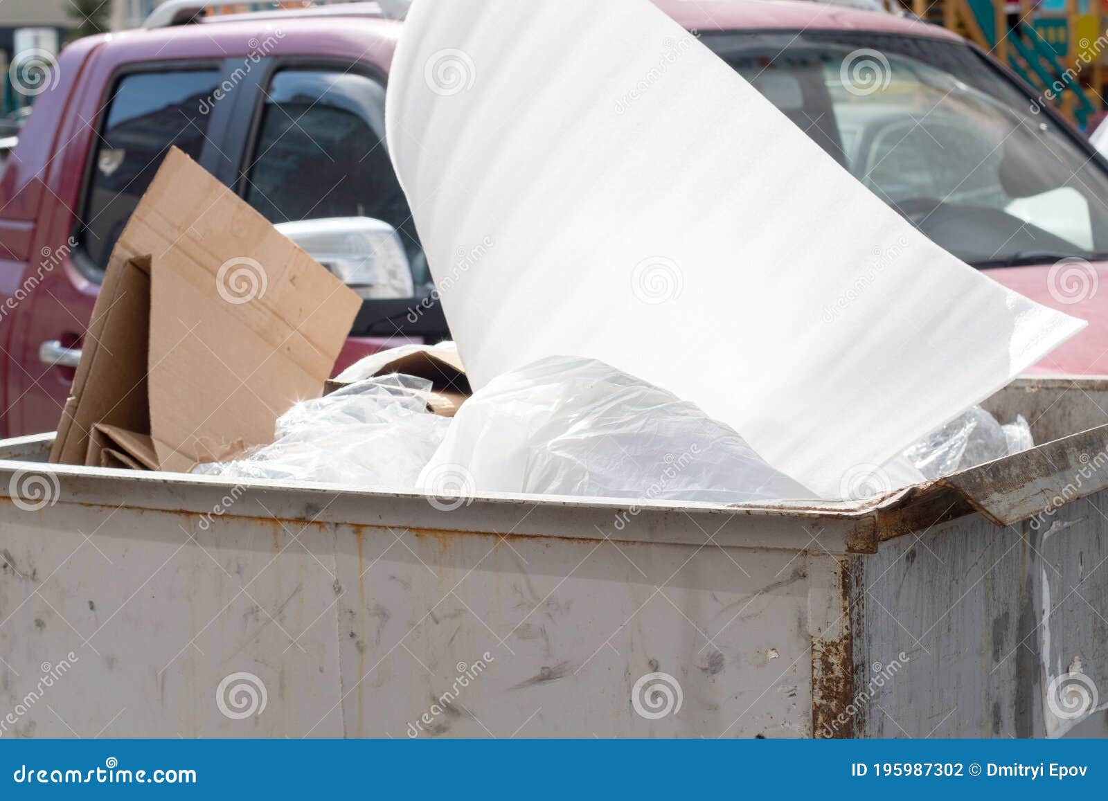 Overflowing Trash Can on a City Street in Front of a Car. Plastic Trash ... Overflowing Trash Can on a City Street in Front of a Car. Plastic Trash ...