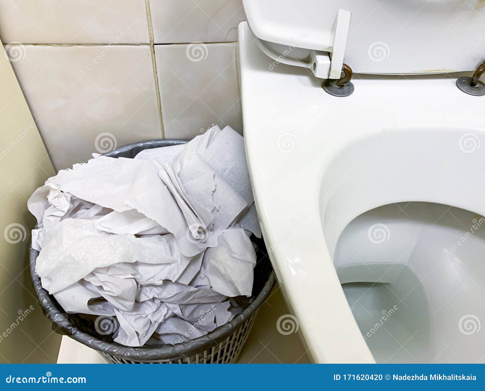 Overflowing Trash Can, Dustbin Full of Used Toilet Paper Near the ... Overflowing Trash Can, Dustbin Full of Used Toilet Paper Near the ...