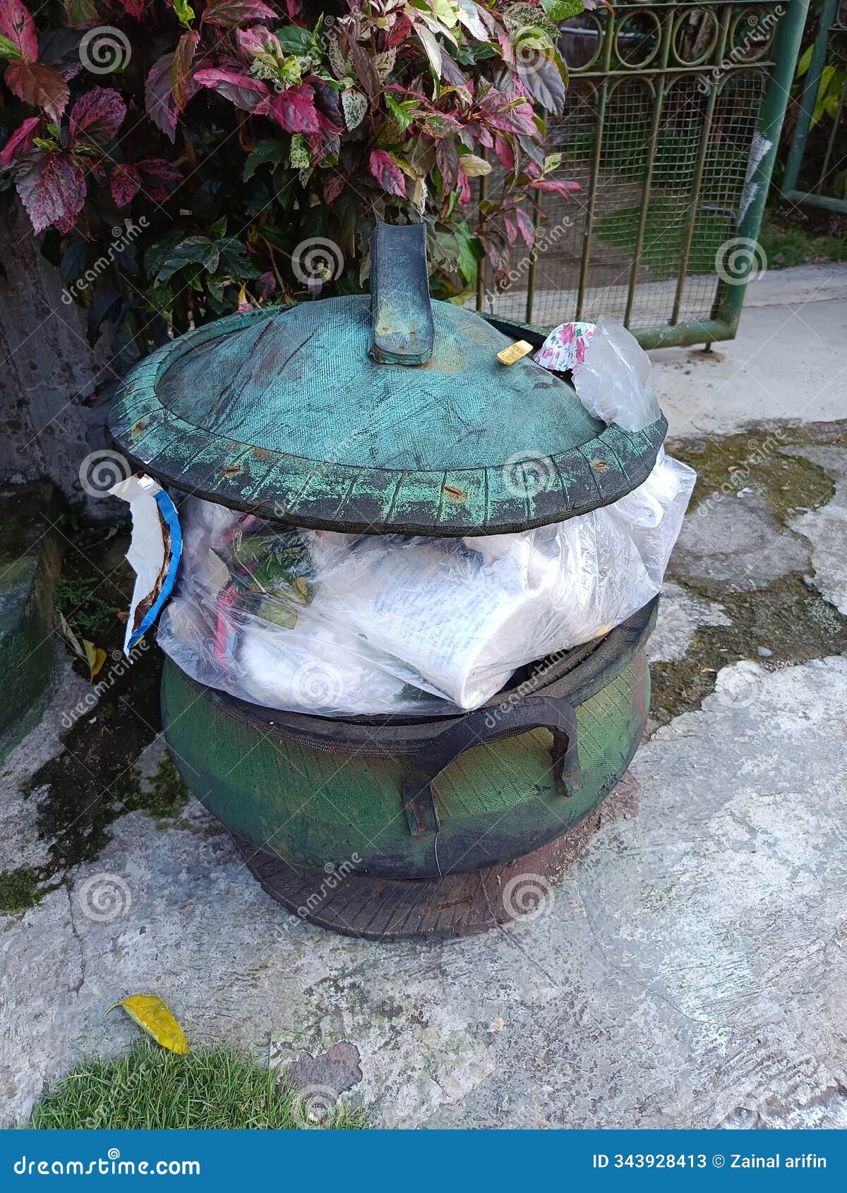 Overflowing Trash Can in a Garden Setting Outdoors Stock Image - Image ...