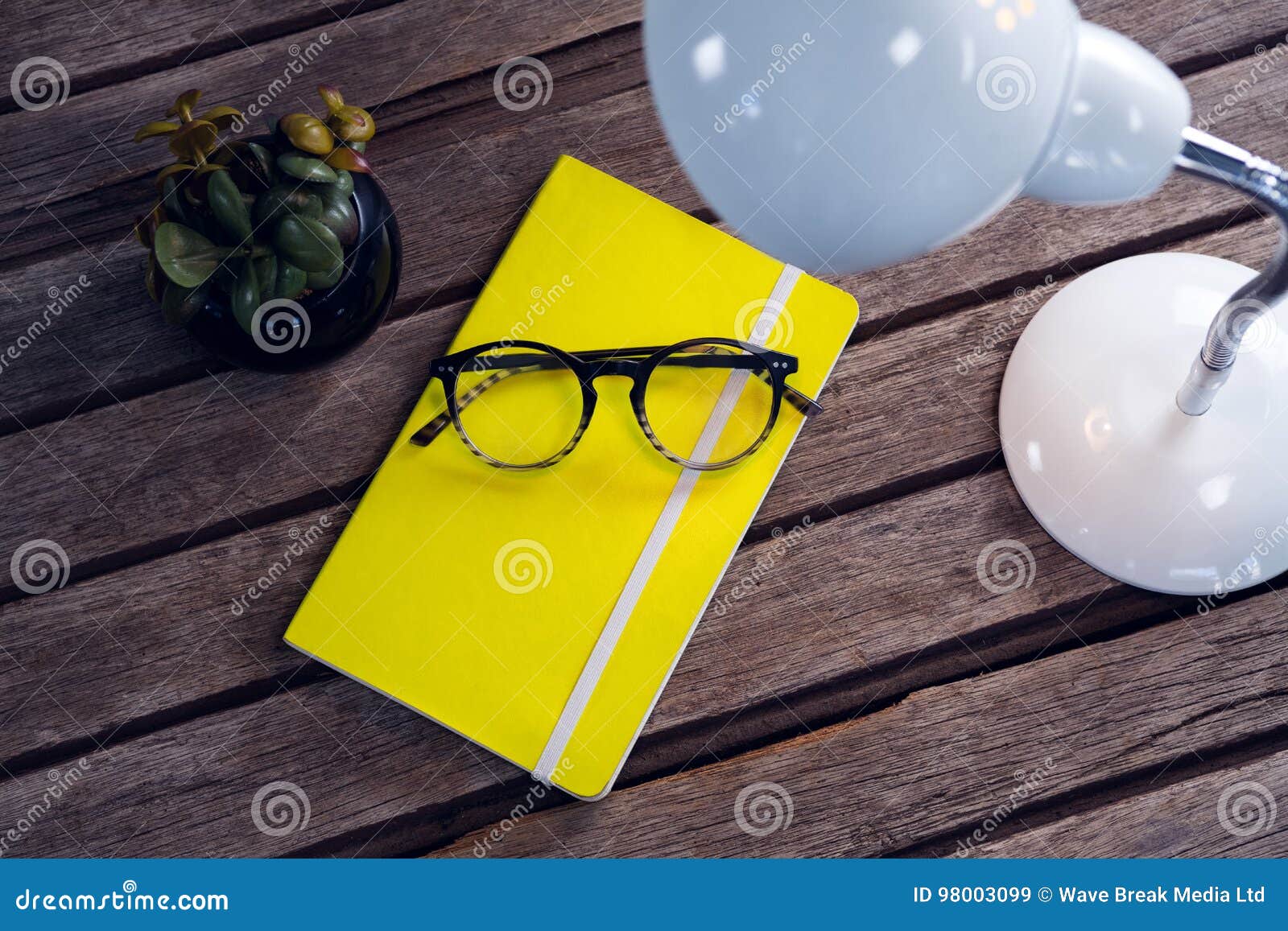 Diary, Spectacles, Pot Plant and Table Lamp on Wooden Table Stock Image ...