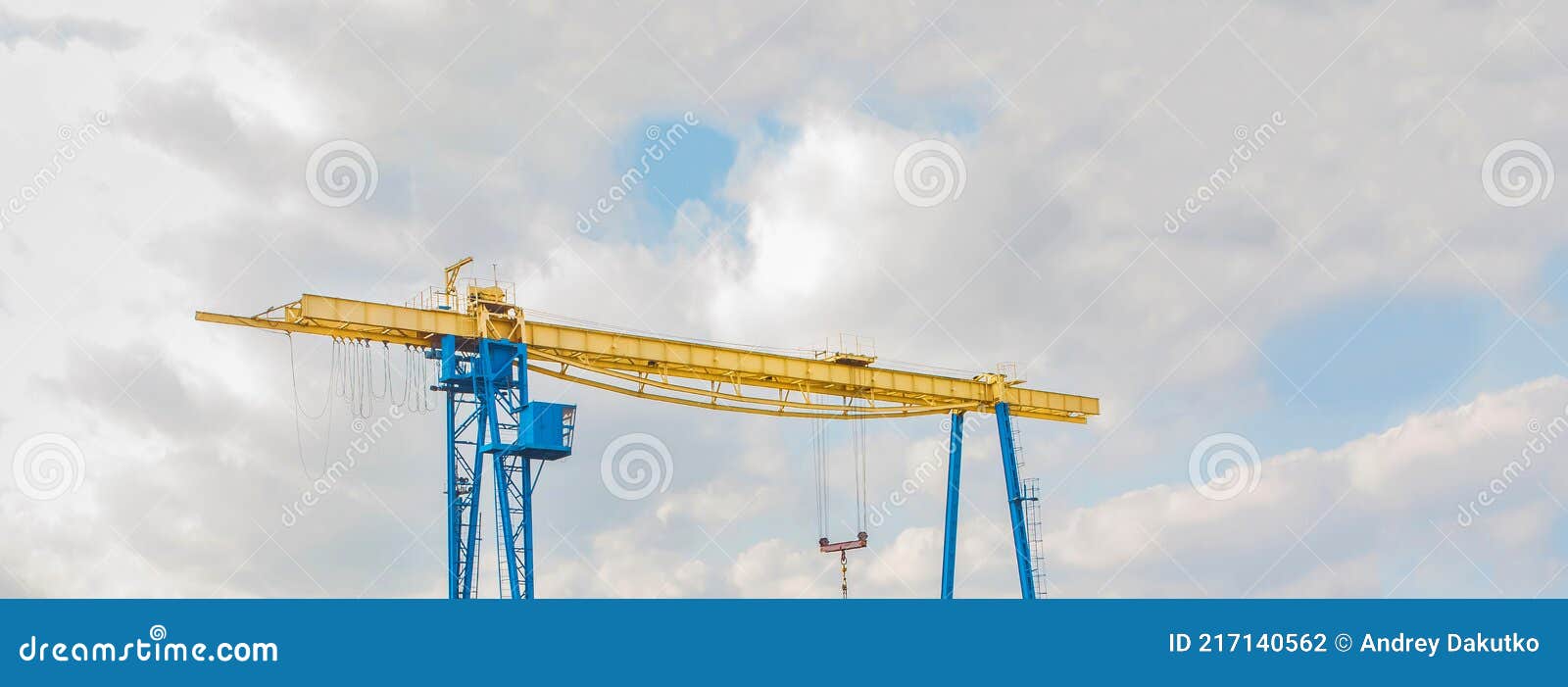 Overhead Industrial Construction Crane on a Background of Blue Sky with ...