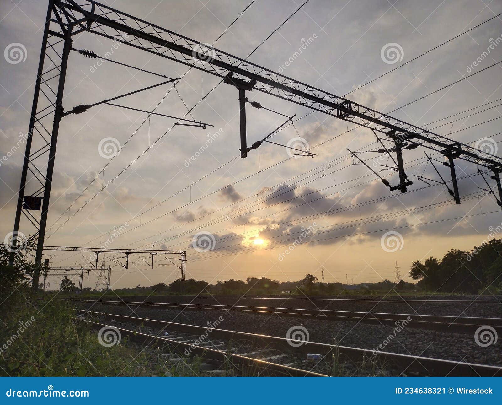 Overhead Lines Over the Empty Rail Tracks Against a Blue Cloudy Sky ...
