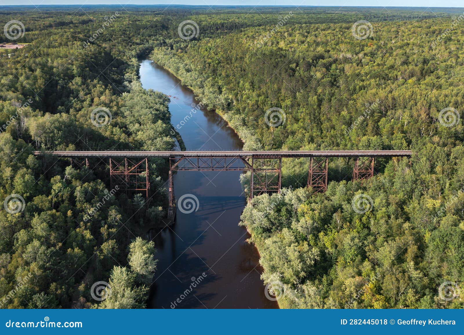 Overhead Railroad Trestle Bridge Over River and Forest Stock Photo ...