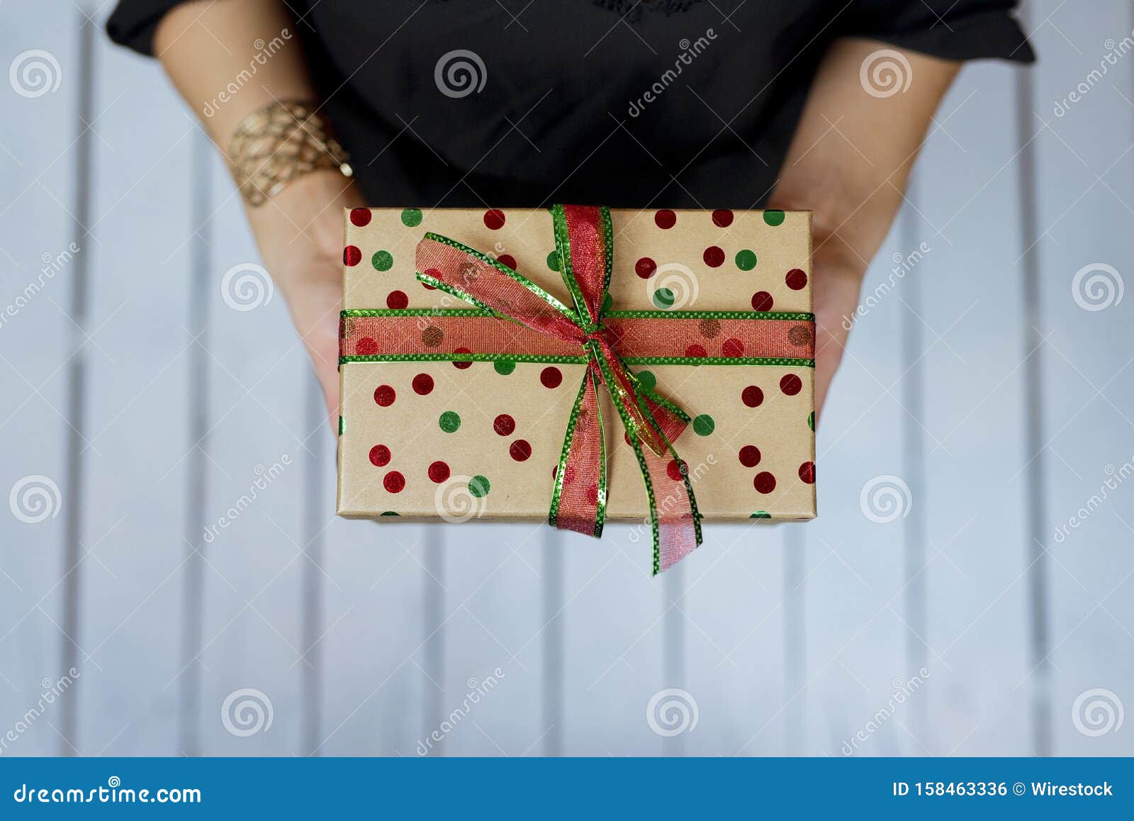 Overhead Selective Closeup Shot of a Person Holding a Decorated Gift ...