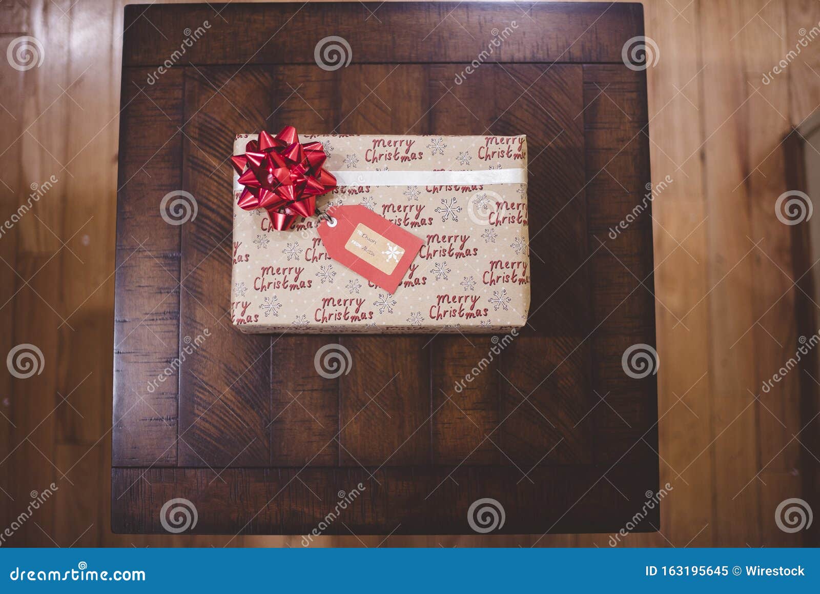 Overhead Shot of a Christmas Present with a Red Bow on a Wooden Table ...