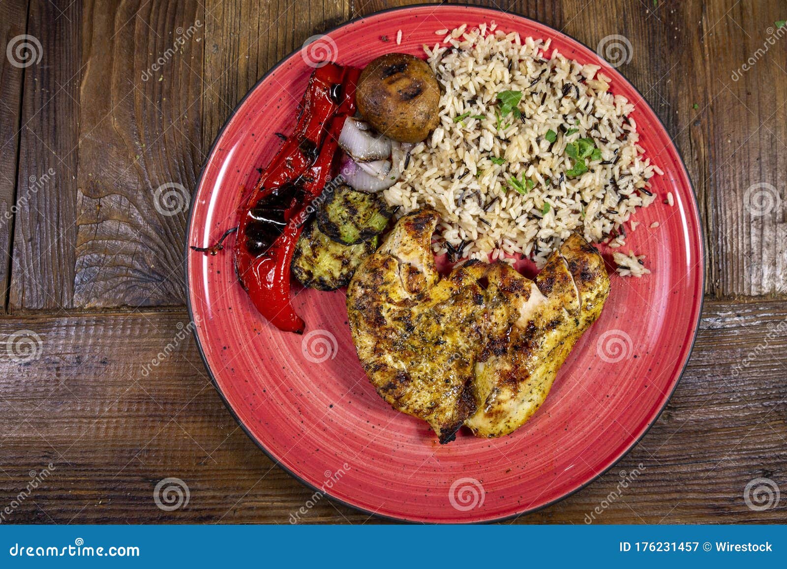 Overhead Shot of a Dinner with Rice, Chicken, and Peppers on a Red ...