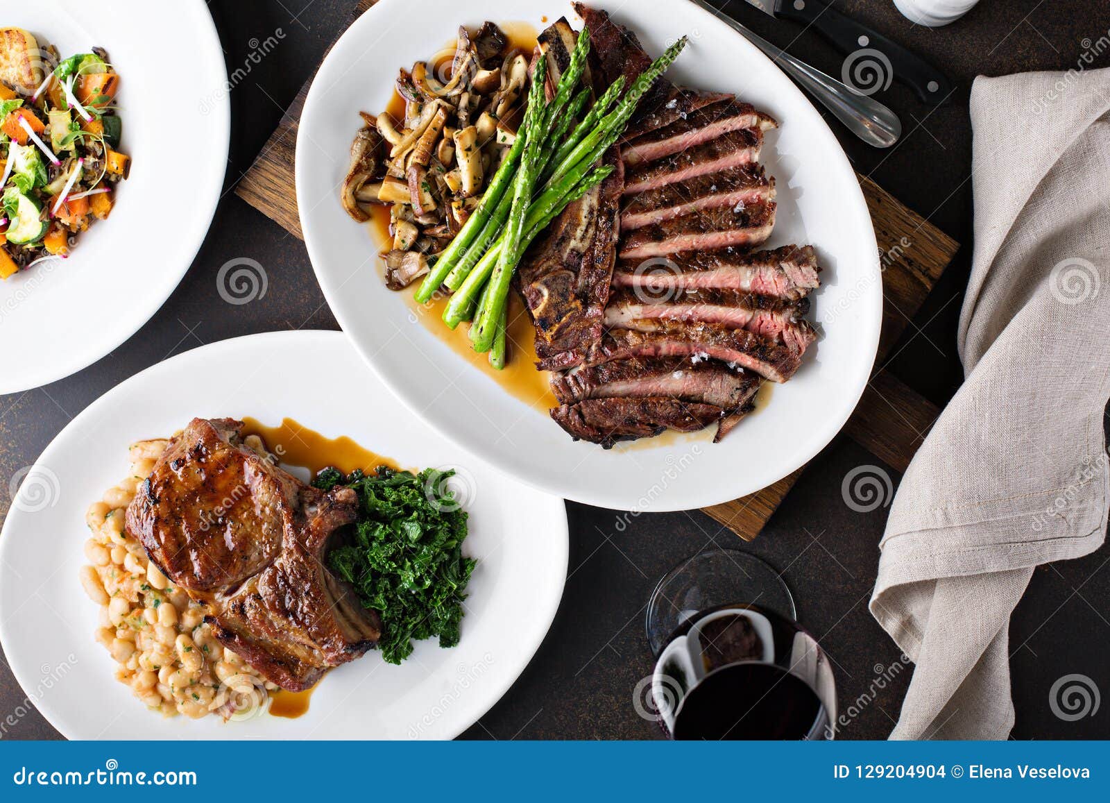 Overhead Shot of a Dinner Table with Steak and Grilled Pork Stock Photo ...