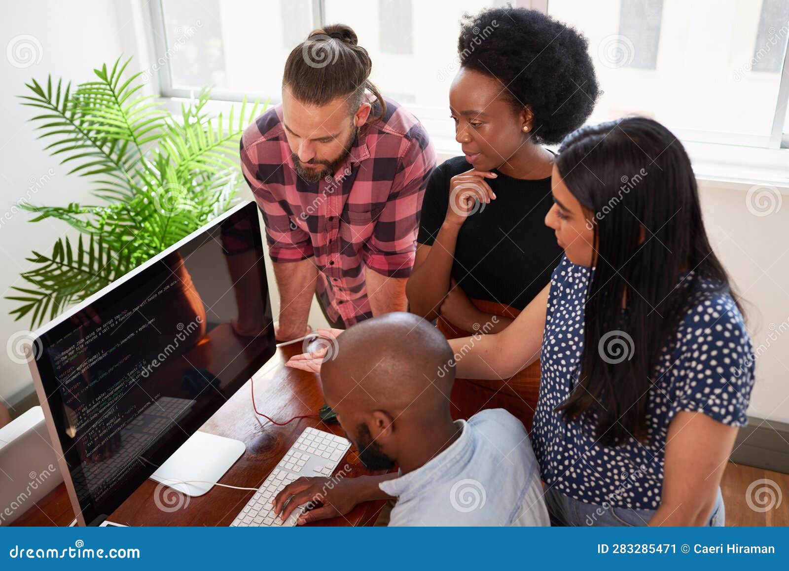 Overhead Shot of Four Developers Working Together, Reviewing Code on ...