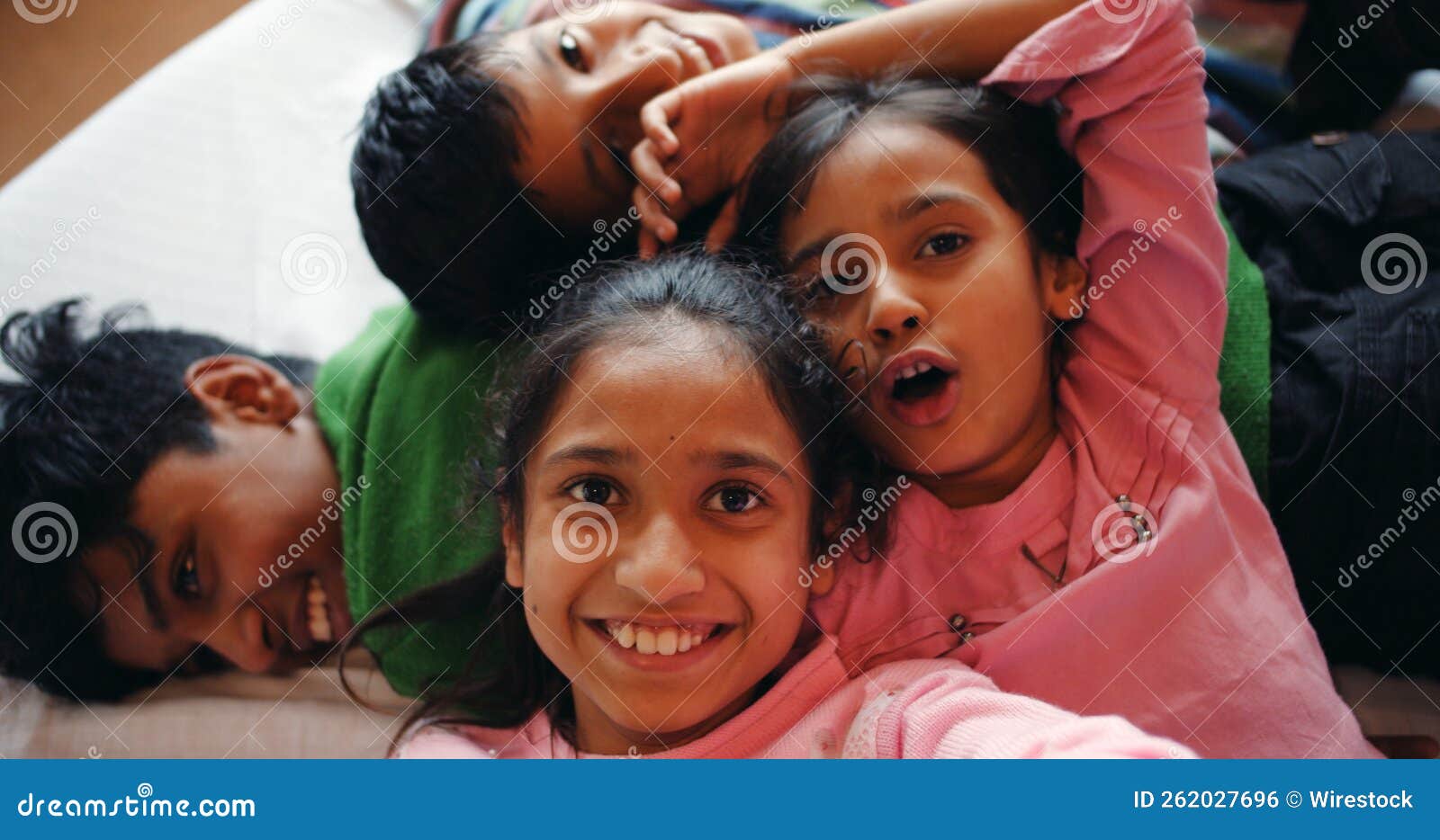 Overhead Shot of Four Siblings Lying on Bed on a Lazy Day Stock Photo ...