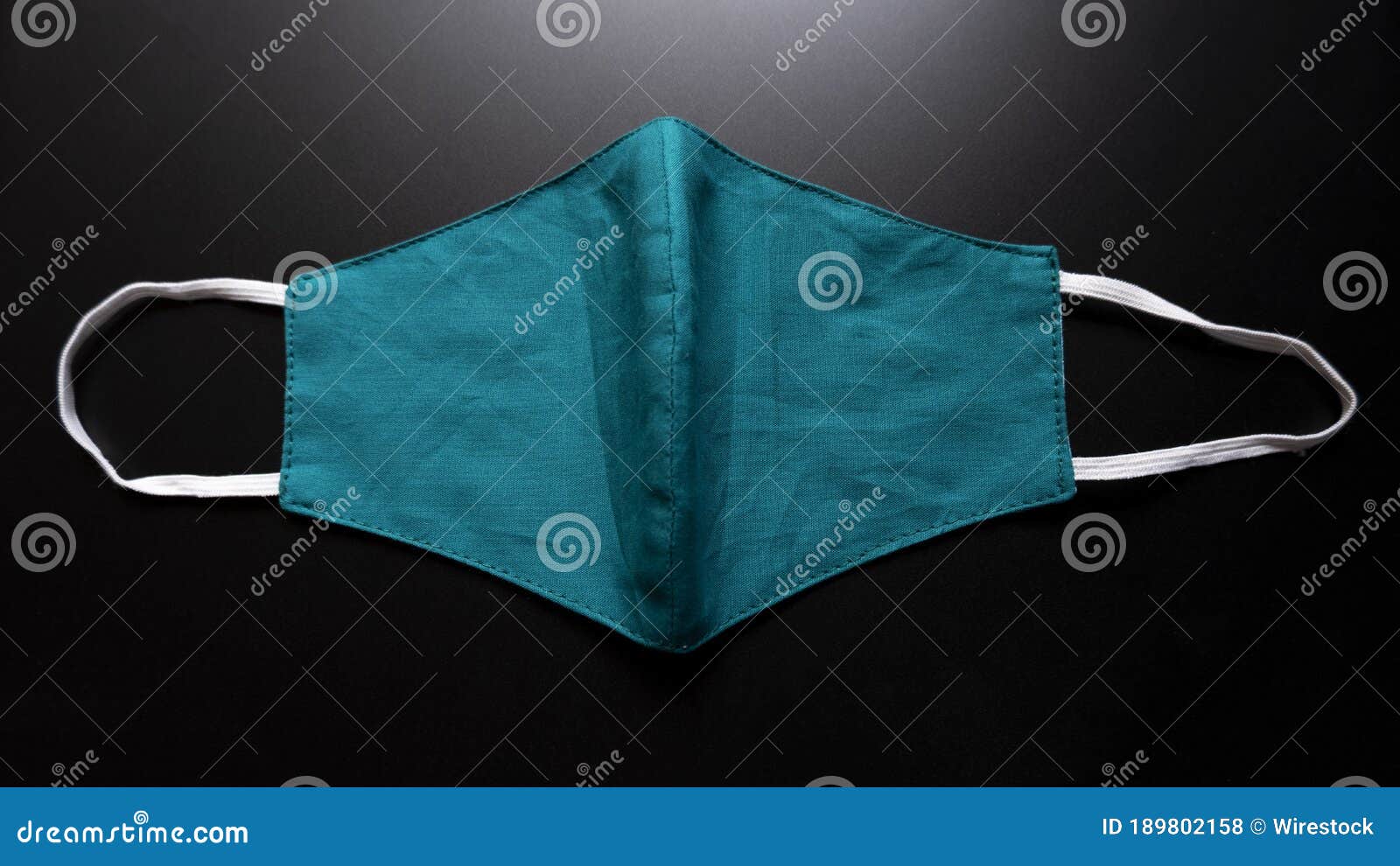 Overhead Shot of a Green-blue Face Mask on a Black Surface Stock Photo ...