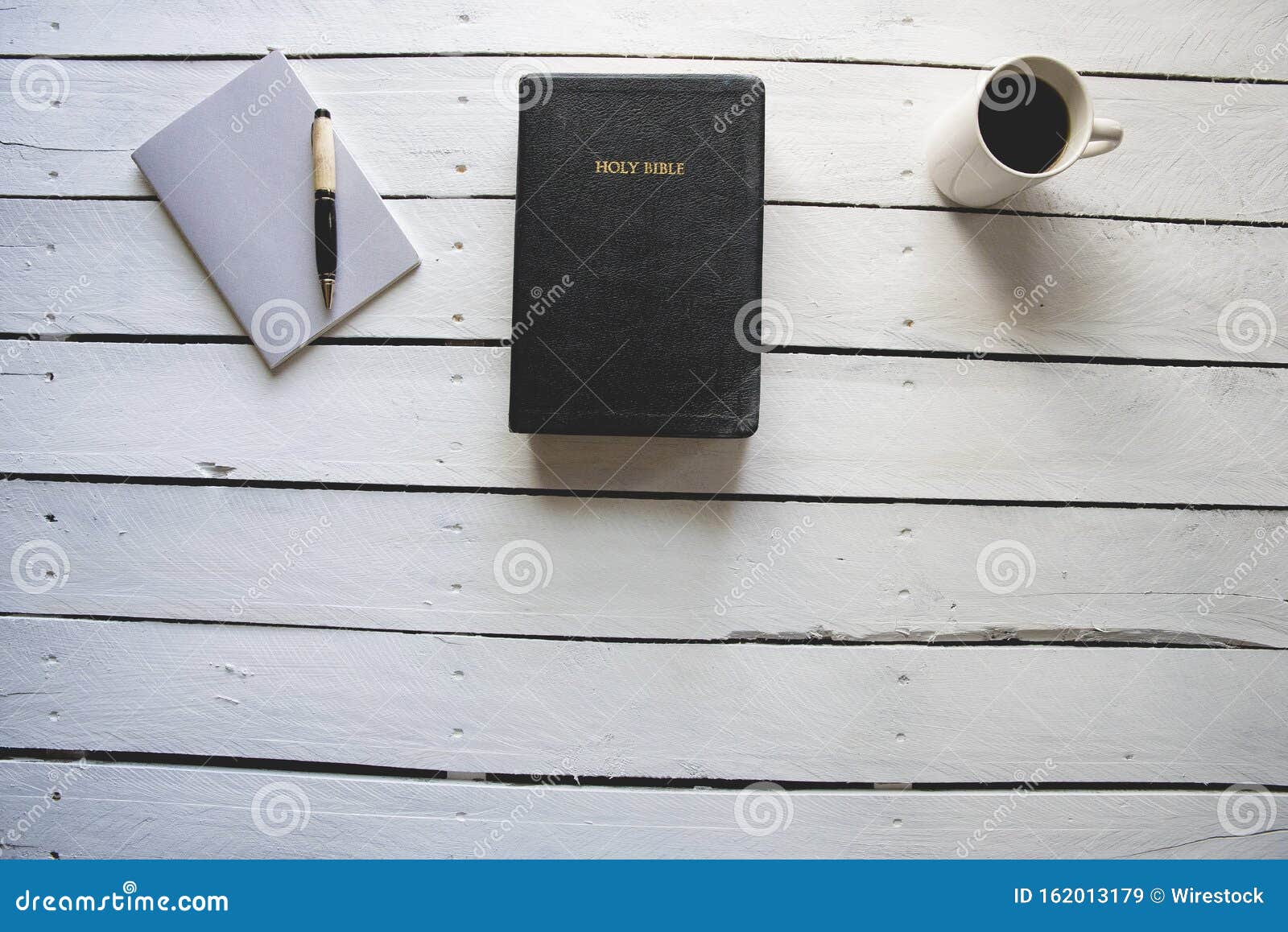 Overhead Shot of the Holy Bible between Coffee and a Notepad with a Pen ...