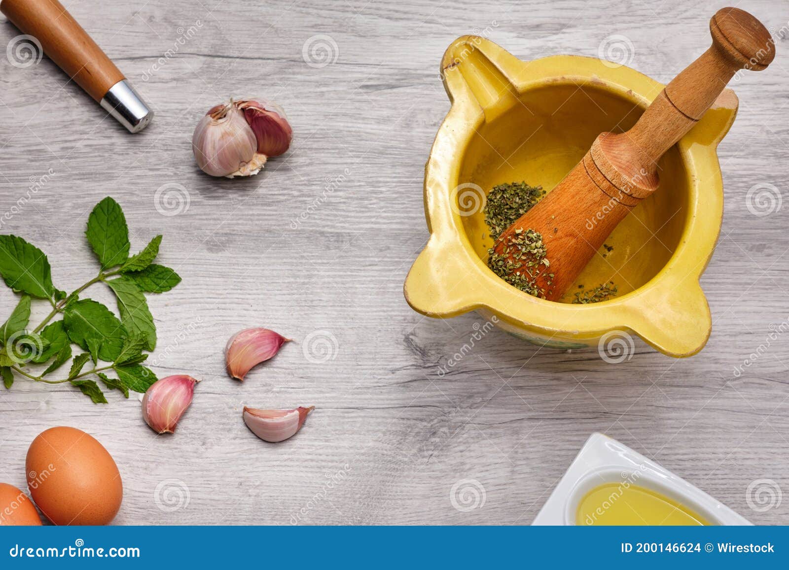 Overhead Shot of a Mortar with Garlic and Eggs and Oil Making ...