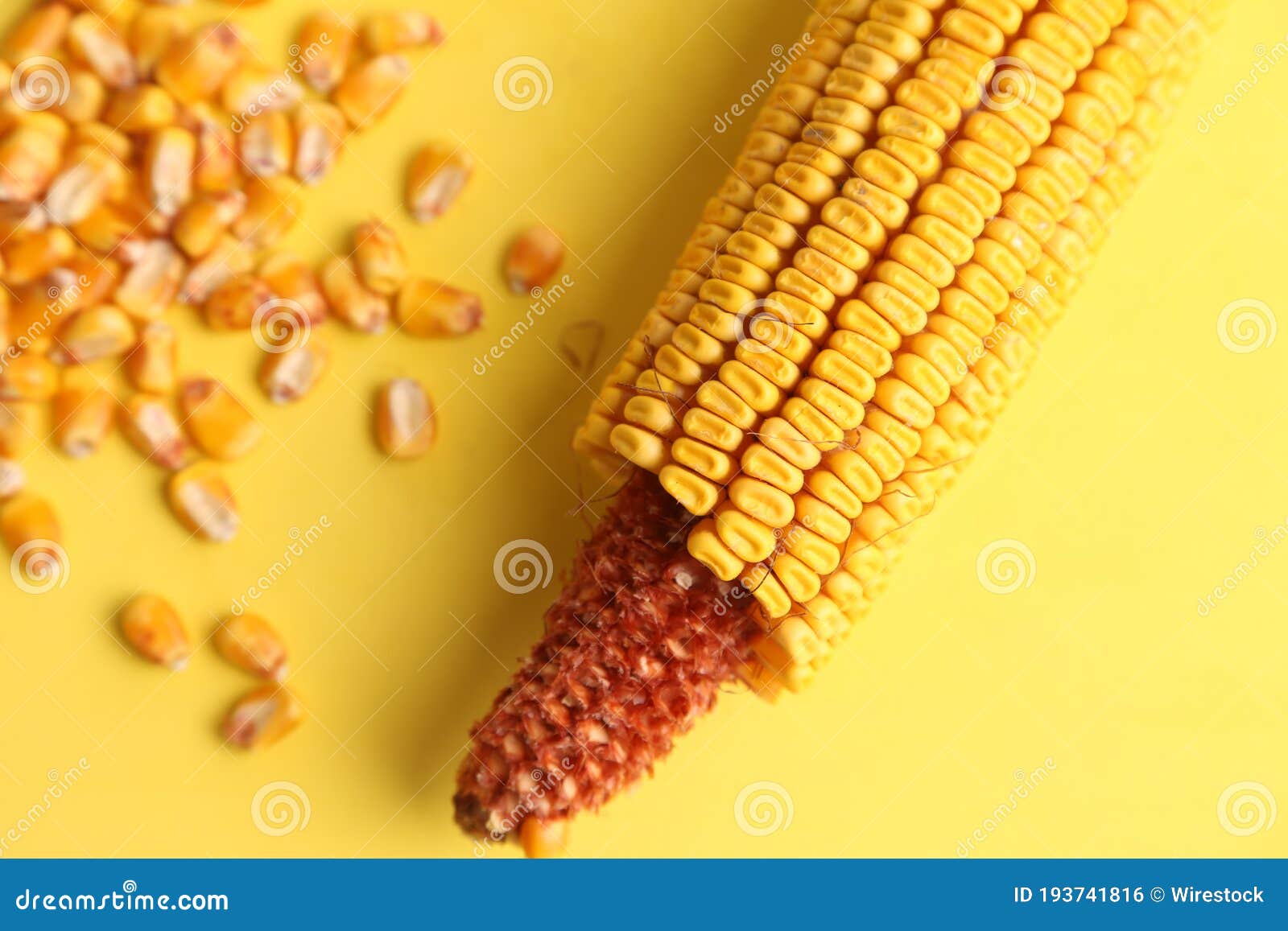 Overhead Shot of a Raw Corn with Partially Removed Kernels on Yellow ...