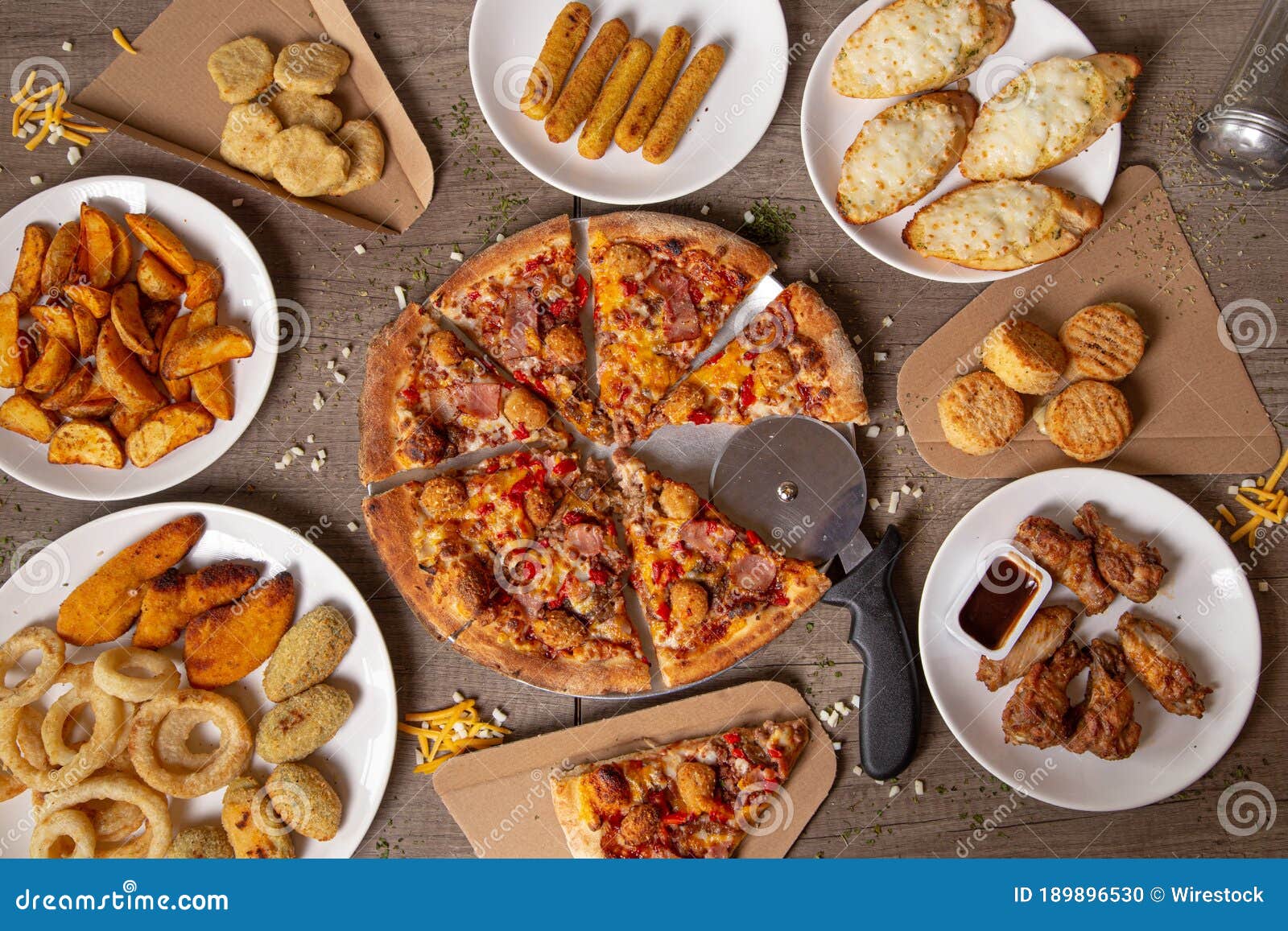 Overhead Shot a Restaurant Table with Sliced Pizza Surrounded by ...