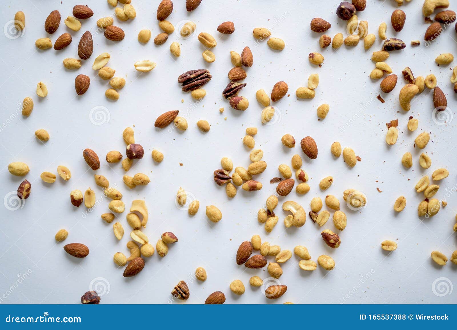 Overhead Shot of Scattered Different Types of Nuts on a White Surface ...
