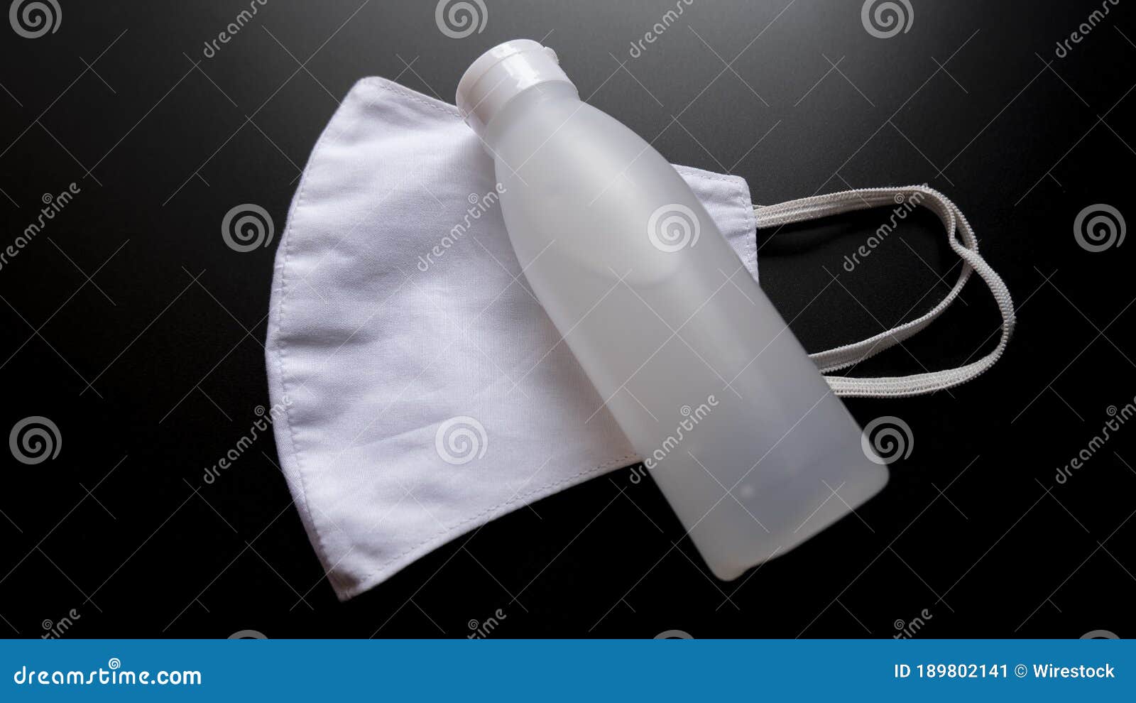 Overhead Shot of a White Face Mask and a Bottle of Rubbing Alcohol on a ...