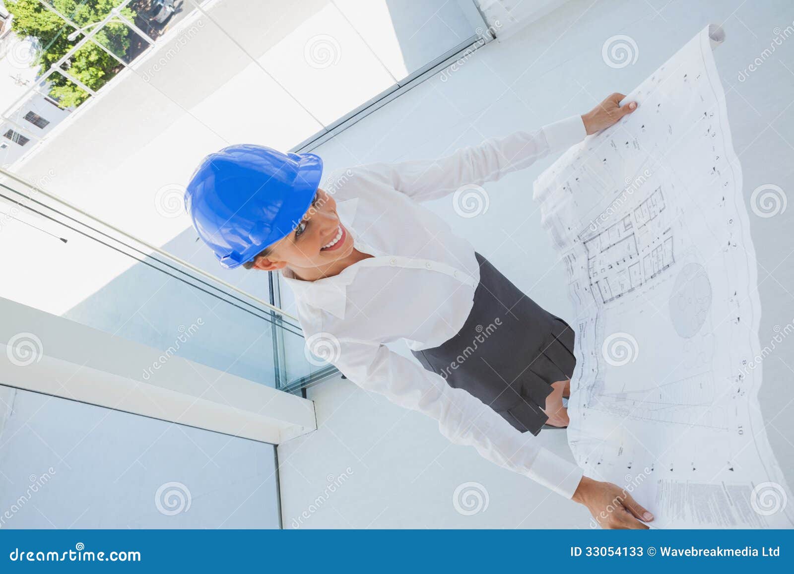 Overhead Of A Smiling Architect Holding A Blueprint Stock Image ...