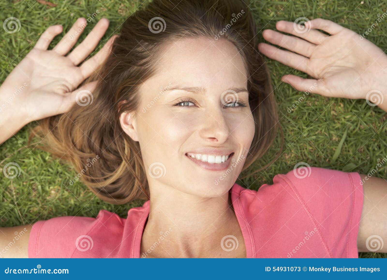 Overhead of Smiling Woman Lying on Grass Stock Image - Image of angle ...