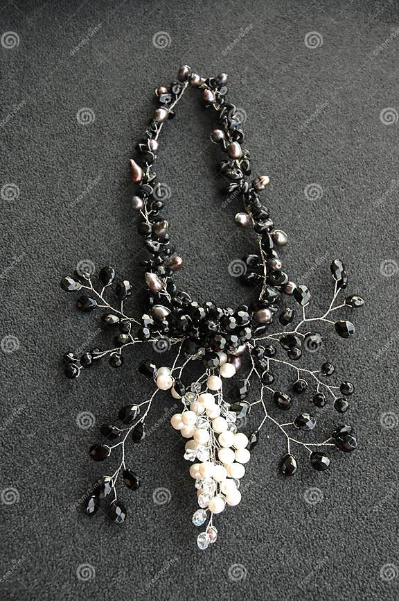 Overhead Vertical Shot of a Black Neckless on a Black Surface Stock ...