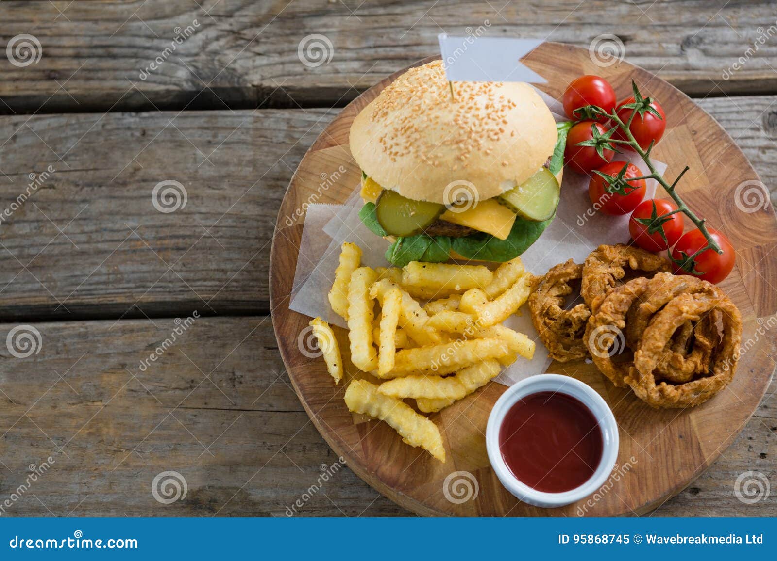 Overhead View of Burger and Fries with Onion Rings by Sauce Stock Image ...
