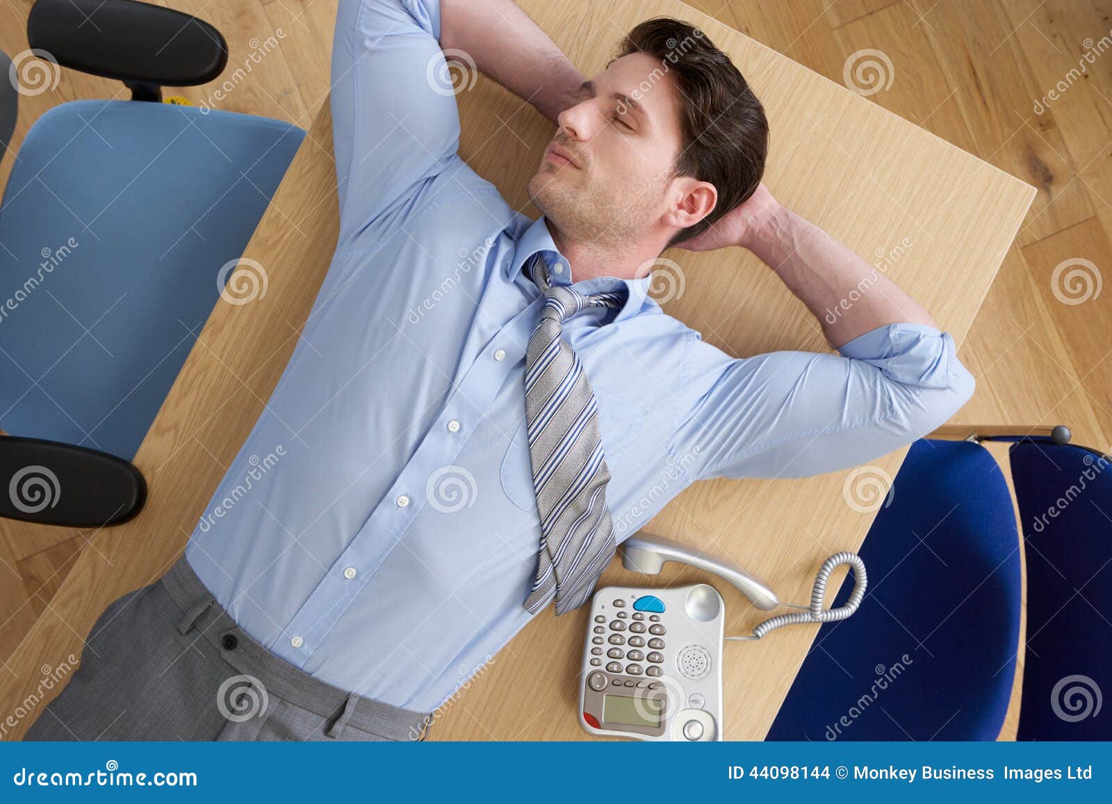 Overhead View of Businessman Lying on Desk in Office Stock Photo ...