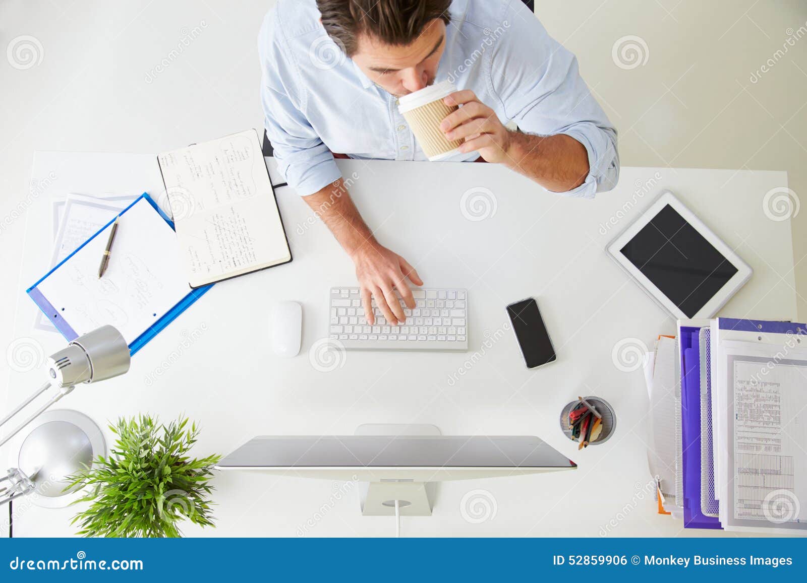 Overhead View of Businessman Working at Computer in Office Stock Photo ...