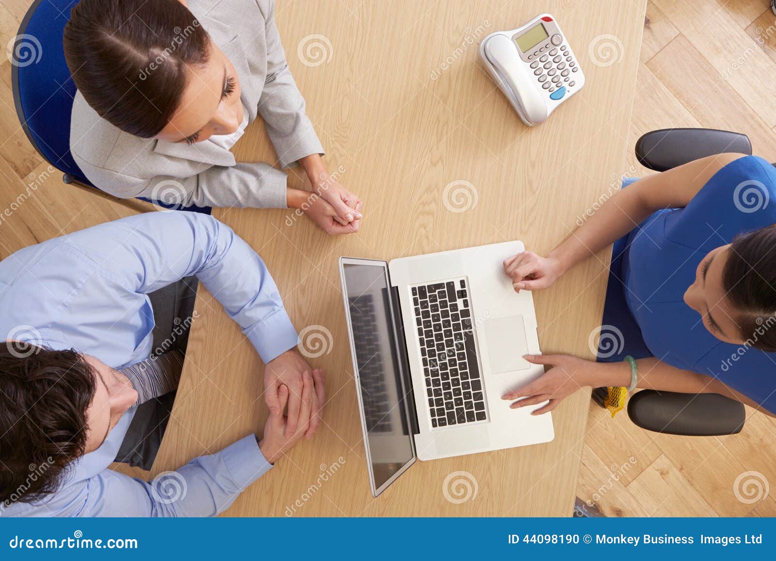 Overhead View of Businesspeople Using Laptop in Office Stock Photo ...