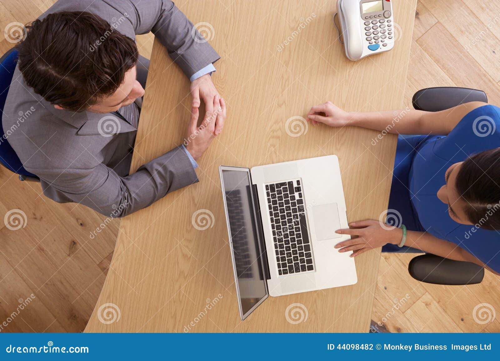 Overhead View of Businesspeople Using Laptop in Office Stock Photo ...
