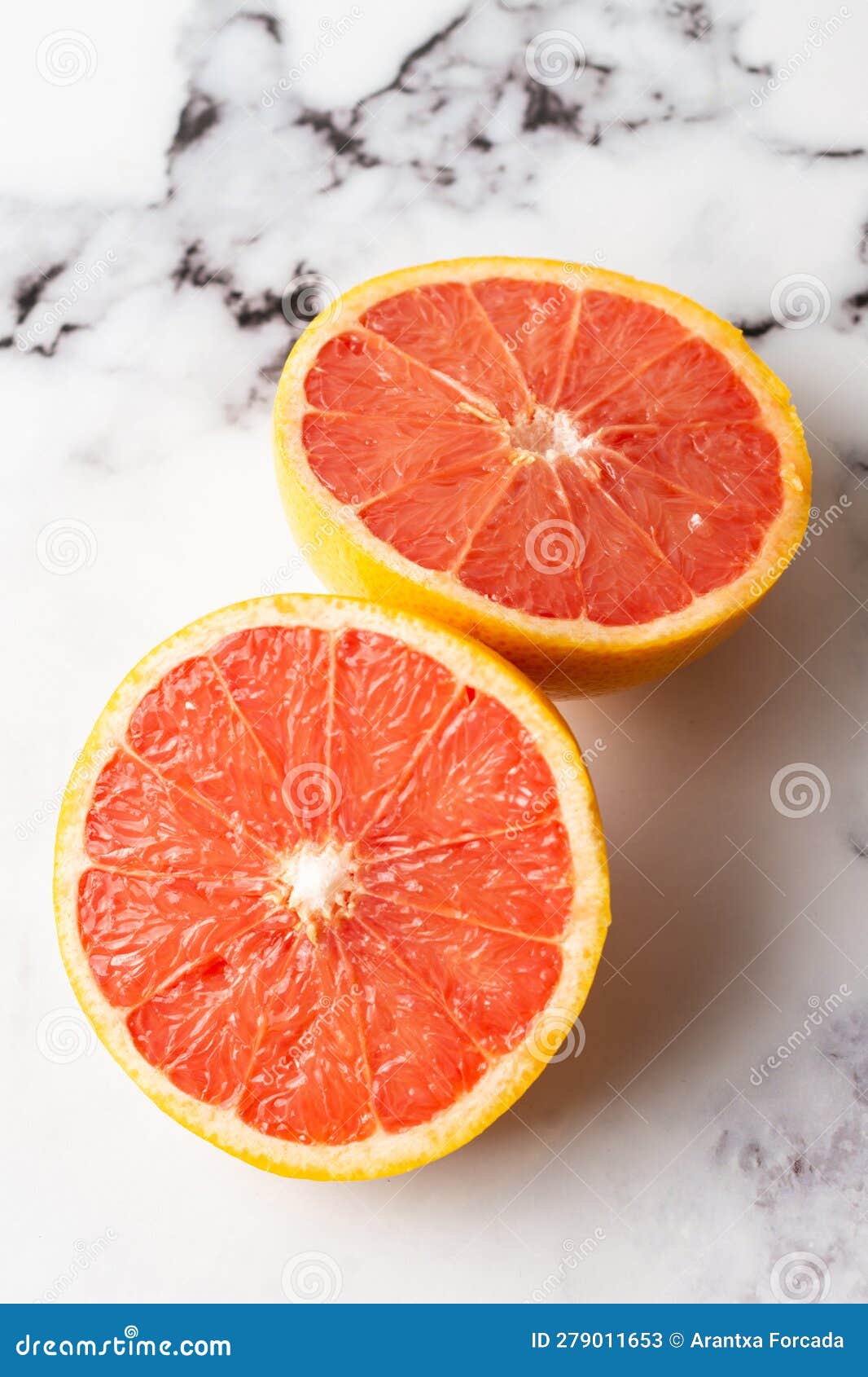 Overhead View of a Cut Red Grapefruit on White Marble Table, Vertical ...