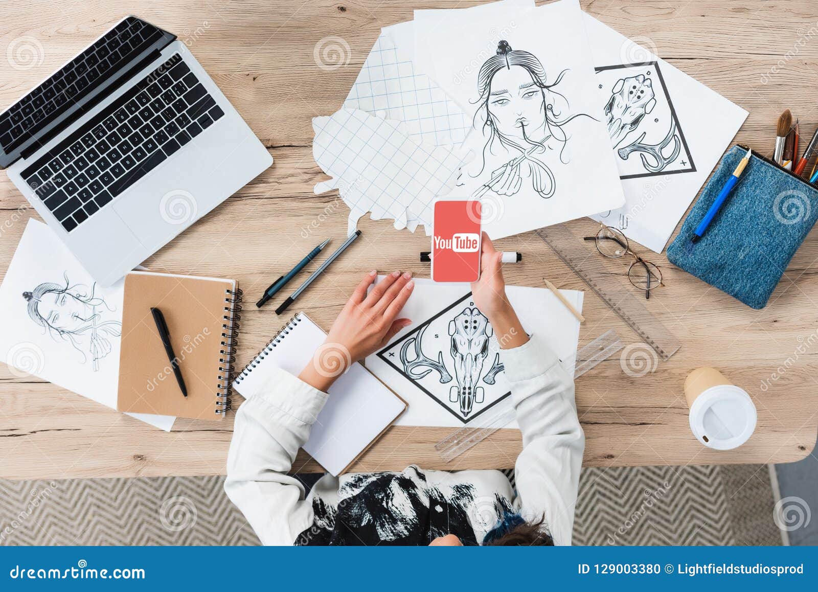 Overhead View of Female Designer Using Smartphone with Youtube ...