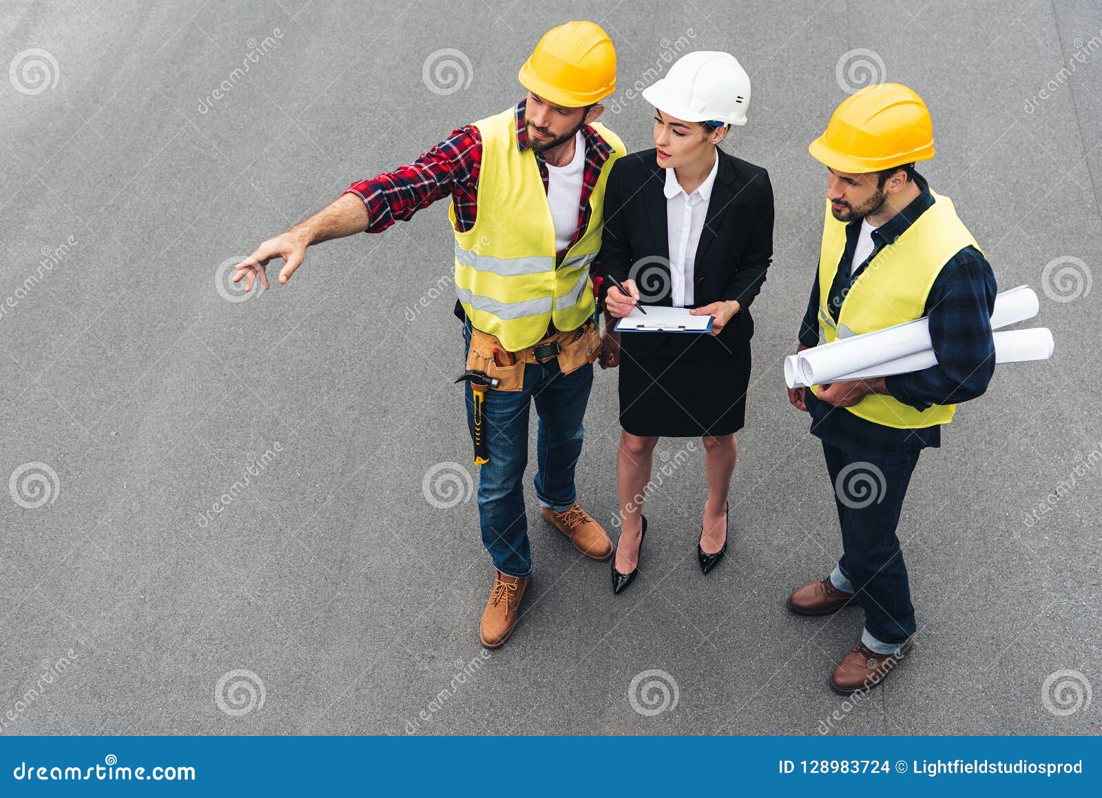 Overhead View of Female Engineer and Male Workers with Clipboard and ...