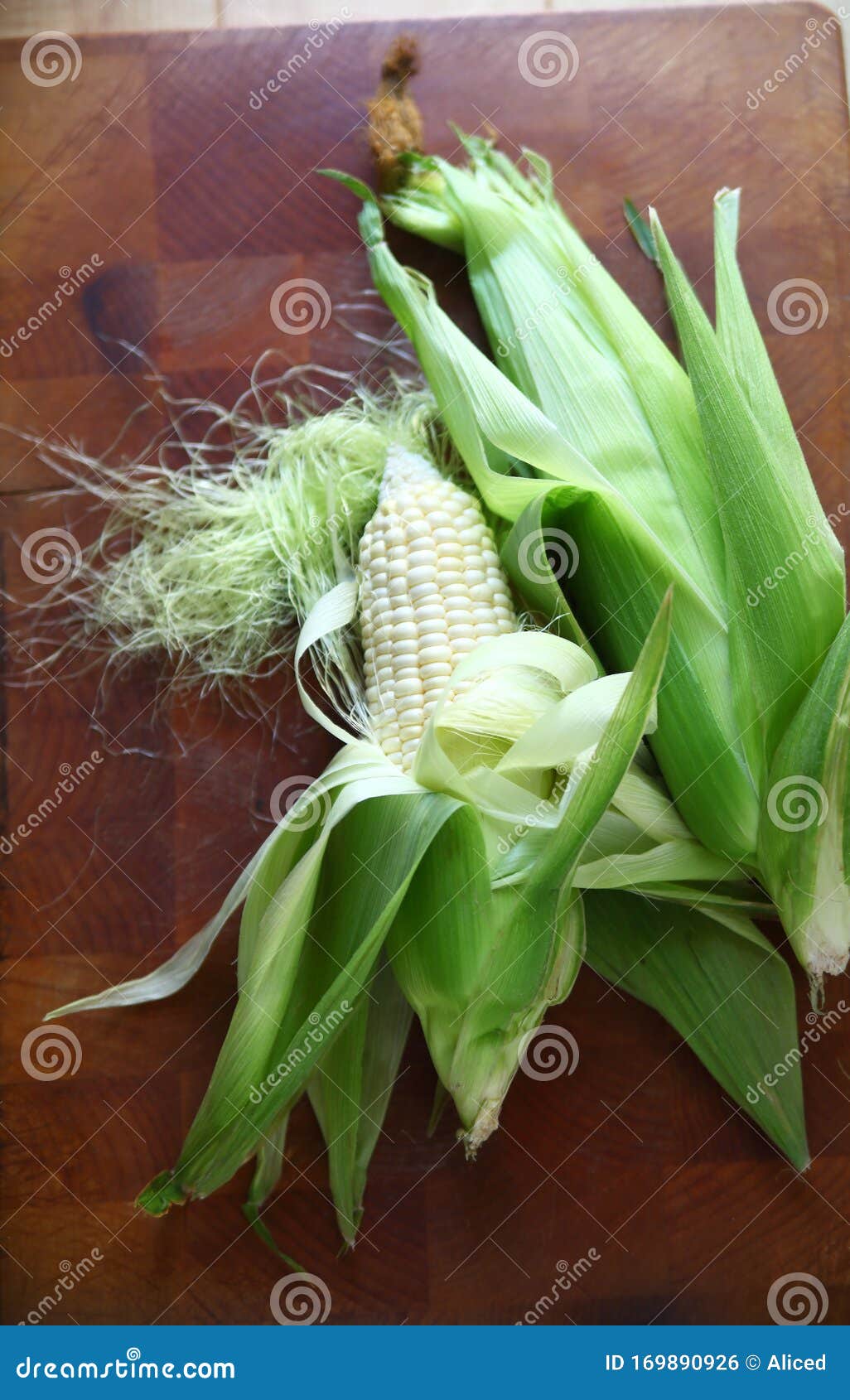 Two Ears of Corn on Cutting Board Stock Photo - Image of sweet ...