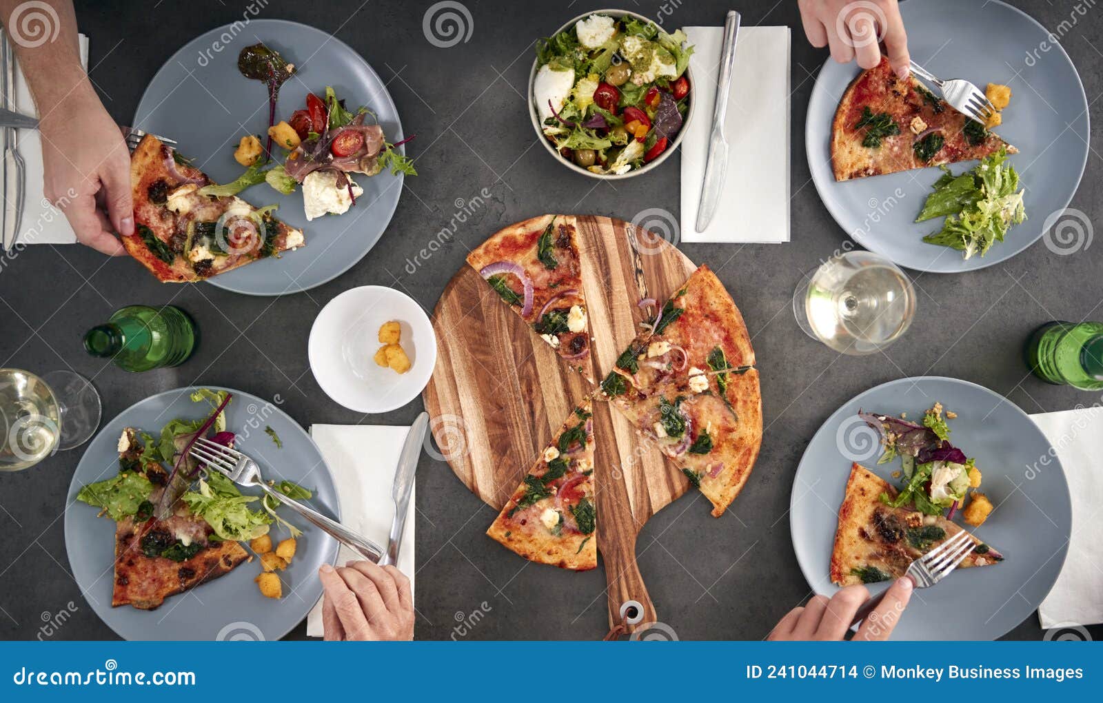 Overhead View of Friends Eating Pizza in Restaurant Together Stock ...