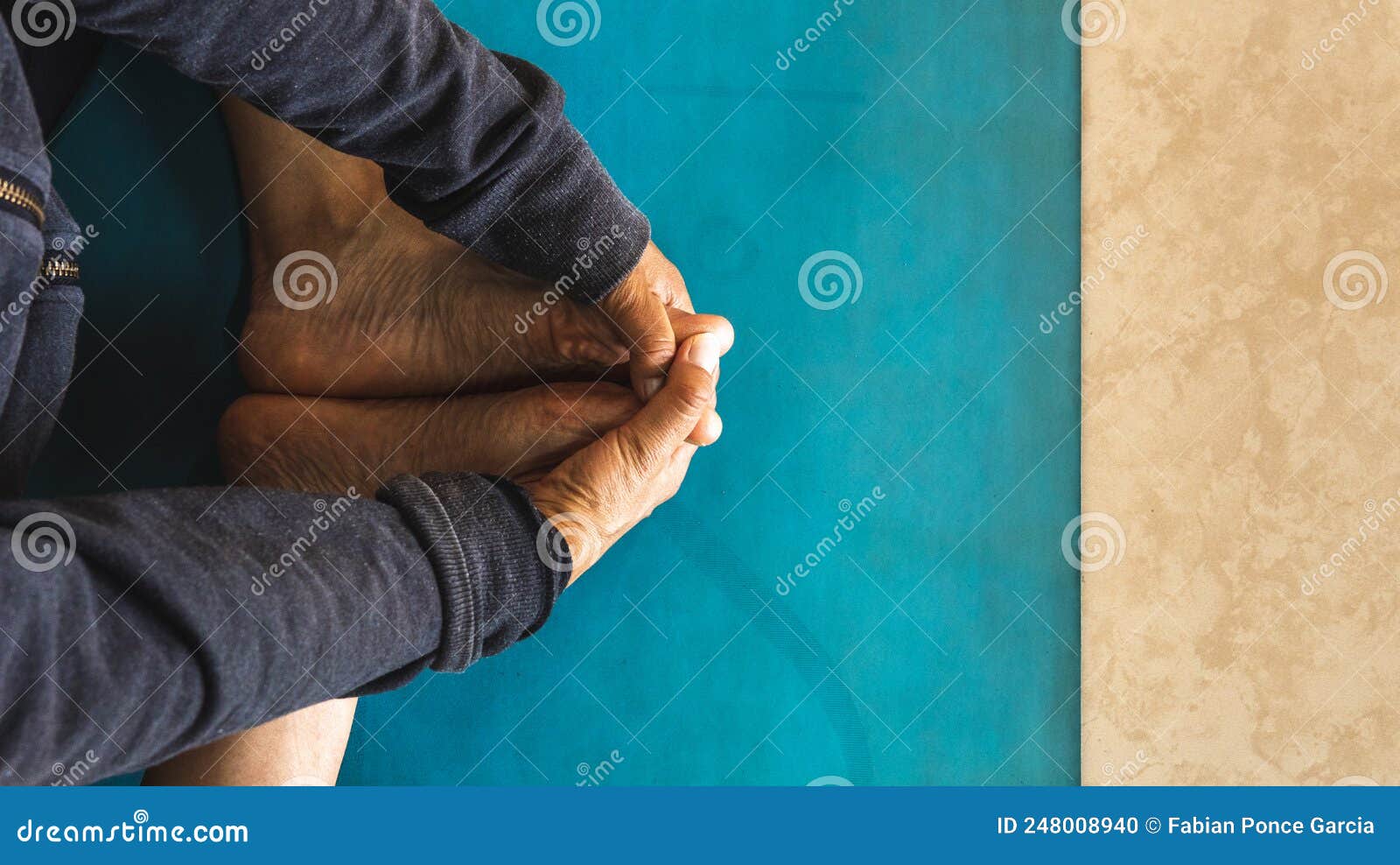 Overhead View of Hands Holding Feet during a Stretch in Yoga Practice ...
