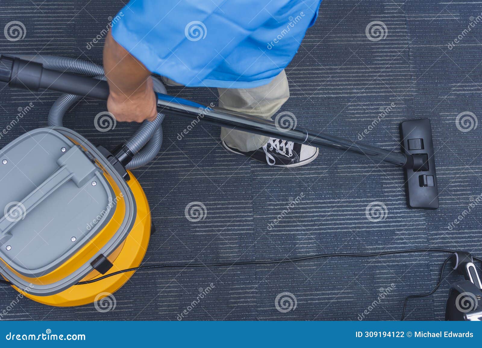 Overhead View of a Janitor Using a Vacuum Cleaner on a Carpet ...