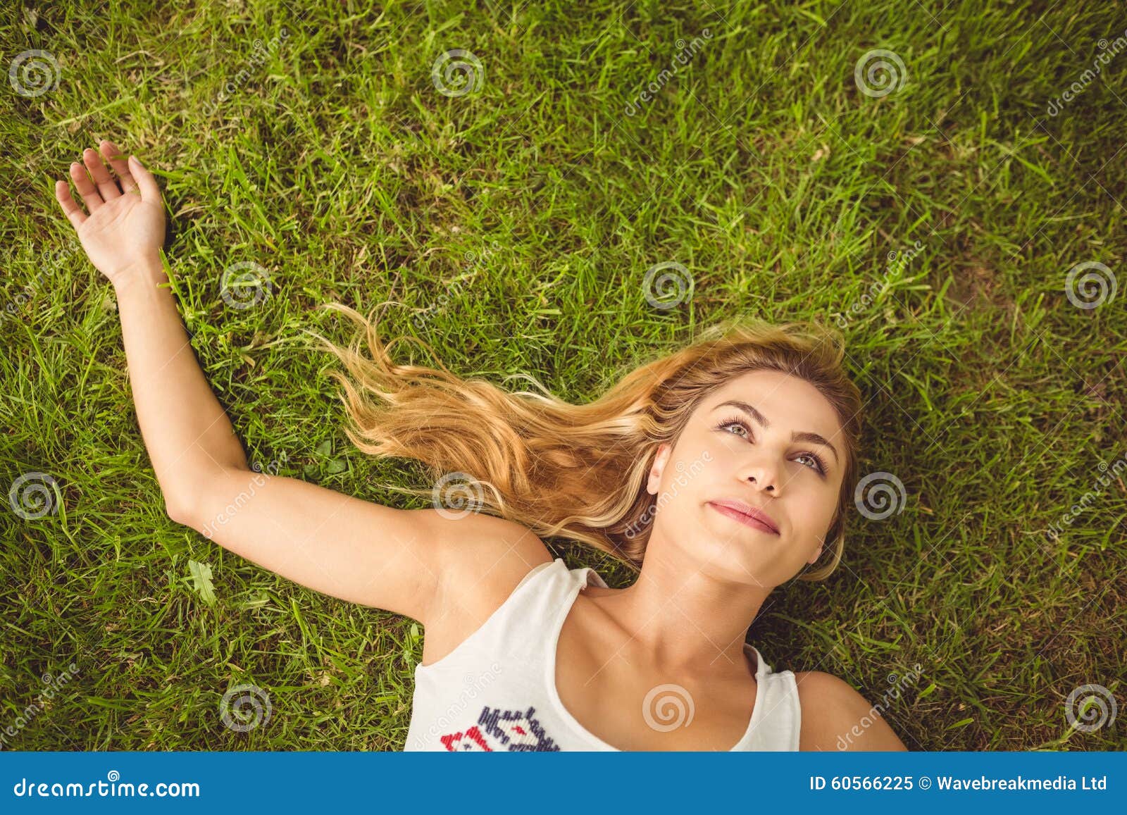 Overhead View of Smiling Woman Lying on Grass Stock Image - Image of ...
