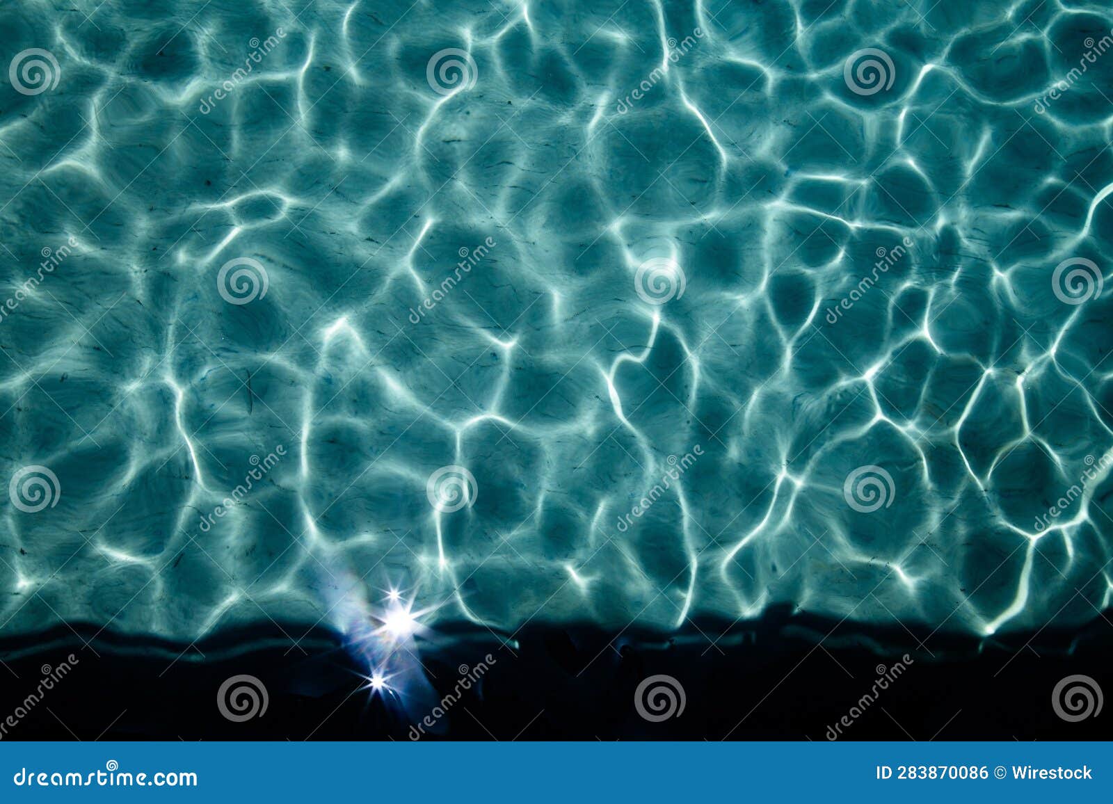 Overhead View of the Surface of a Blue Pool with the Sun Creating ...