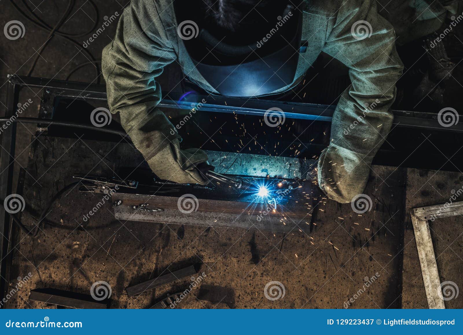 Overhead View of Welder in Protective Work Wear Holding Welding Torch ...