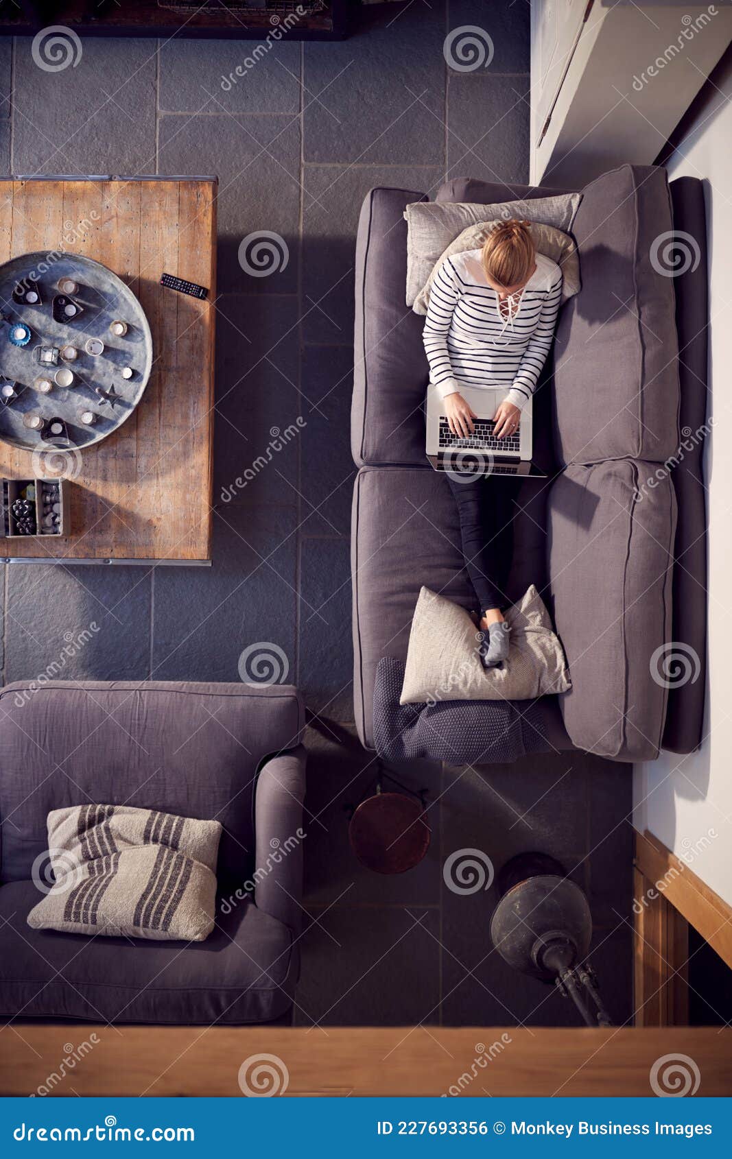 Overhead View of Woman Relaxing on Lounge Sofa at Home Using Laptop ...