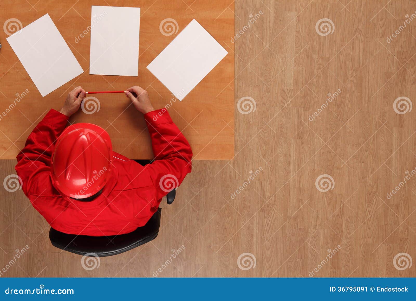 Overhead View of Worker in Red Uniform and Hardhat Reading Papers Stock ...