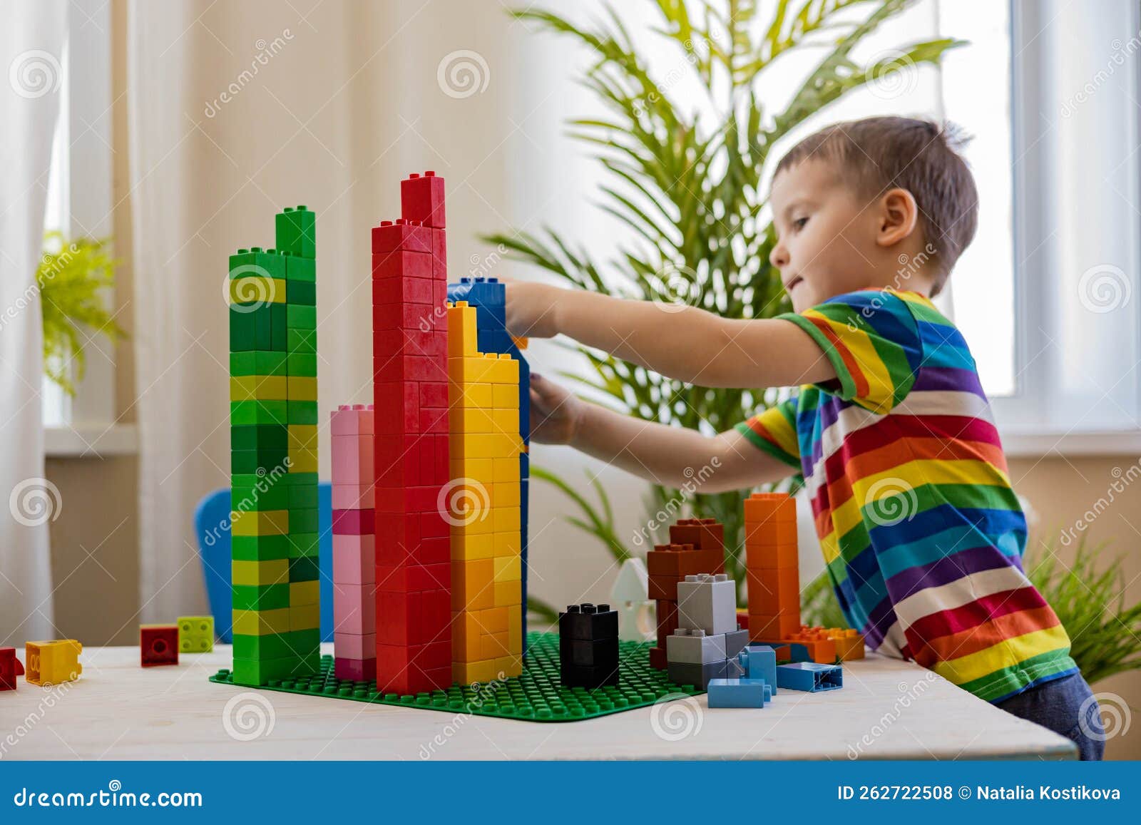 Overjoyed Baby Boy Successful Assembling Multicolored Plastic Blocks ...