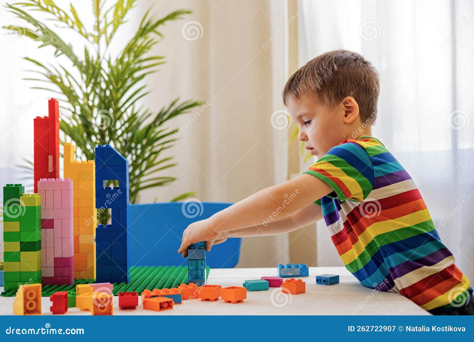 Overjoyed Baby Boy Successful Assembling Multicolored Plastic Blocks ...