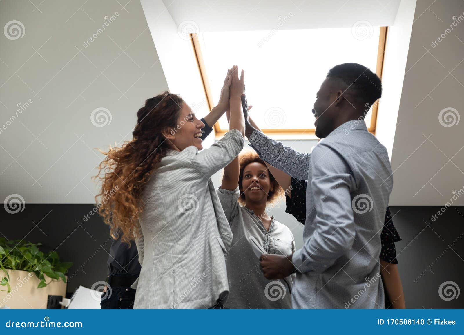 Overjoyed Diverse Colleagues Give High Five for Shared Goal Stock Photo ... Overjoyed Diverse Colleagues Give High Five for Shared Goal Stock Photo ...