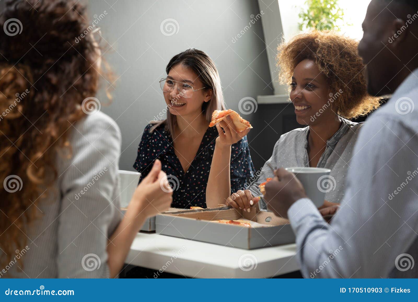 Overjoyed Multiracial Colleagues Have Fun Enjoying Pizza Break In